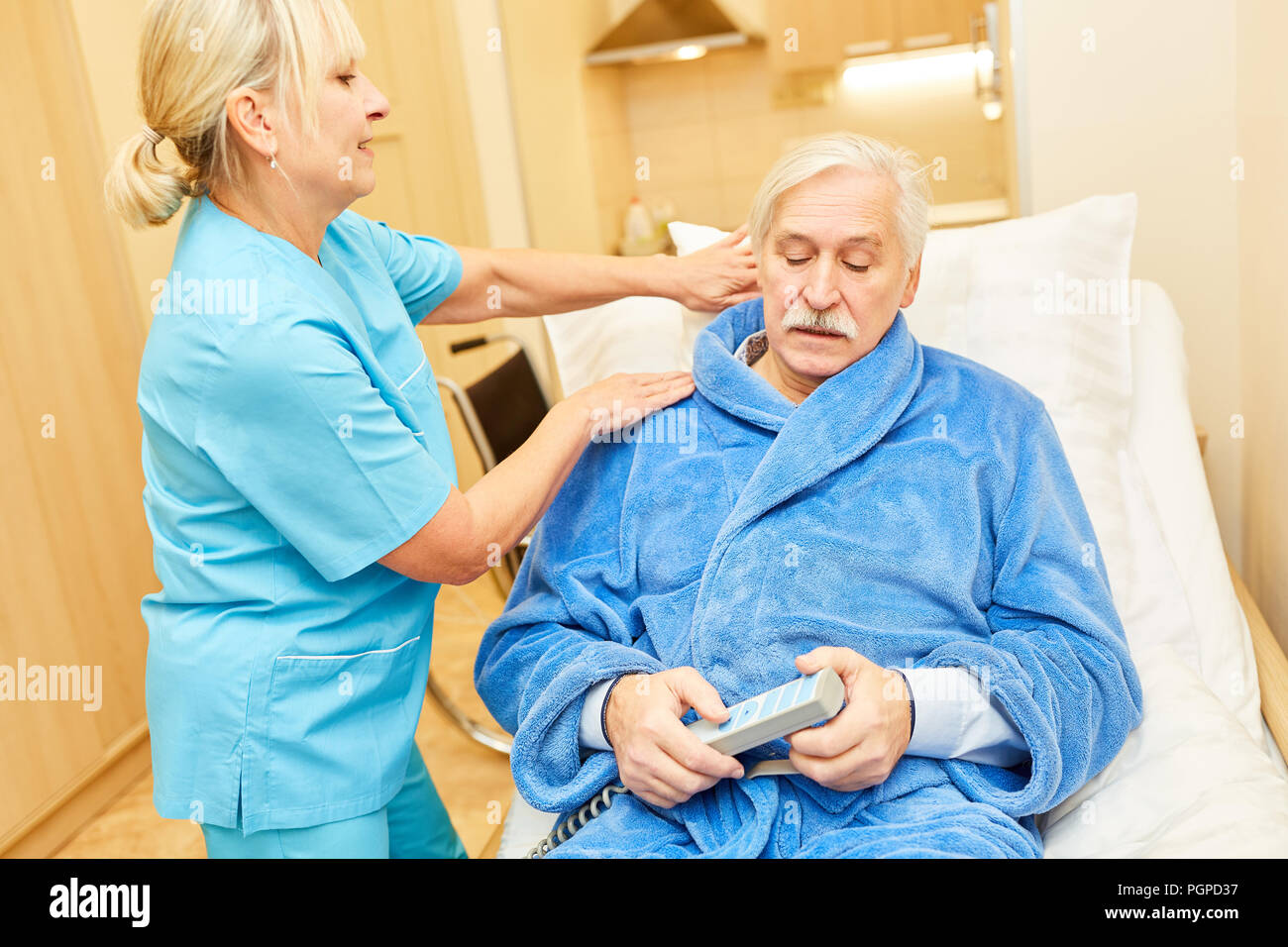 Nurse or nursing assistant looks after a sick senior citizen in a ...