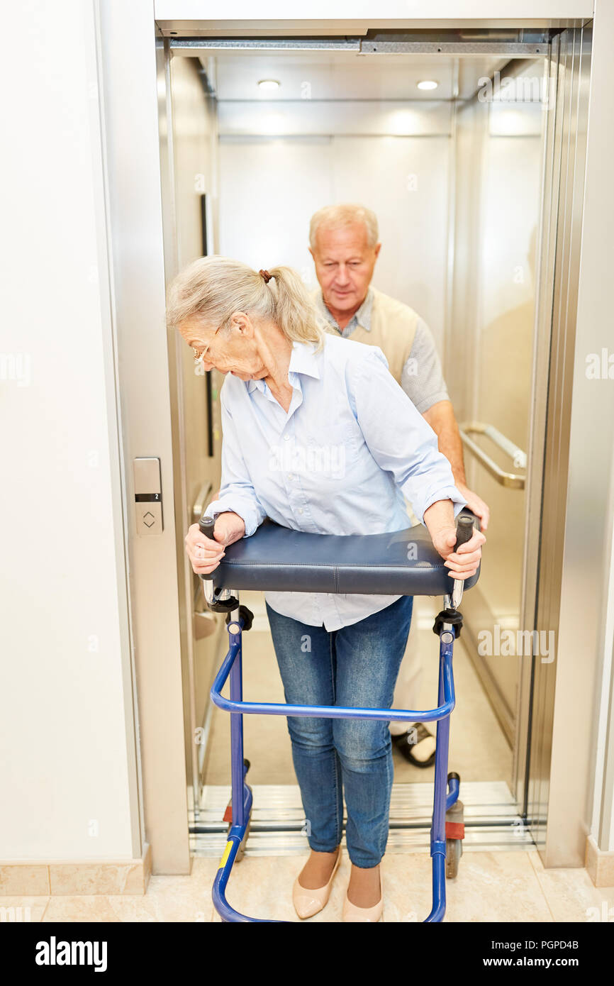Senior with rollator and senior man in an elevator in a nursing home ...