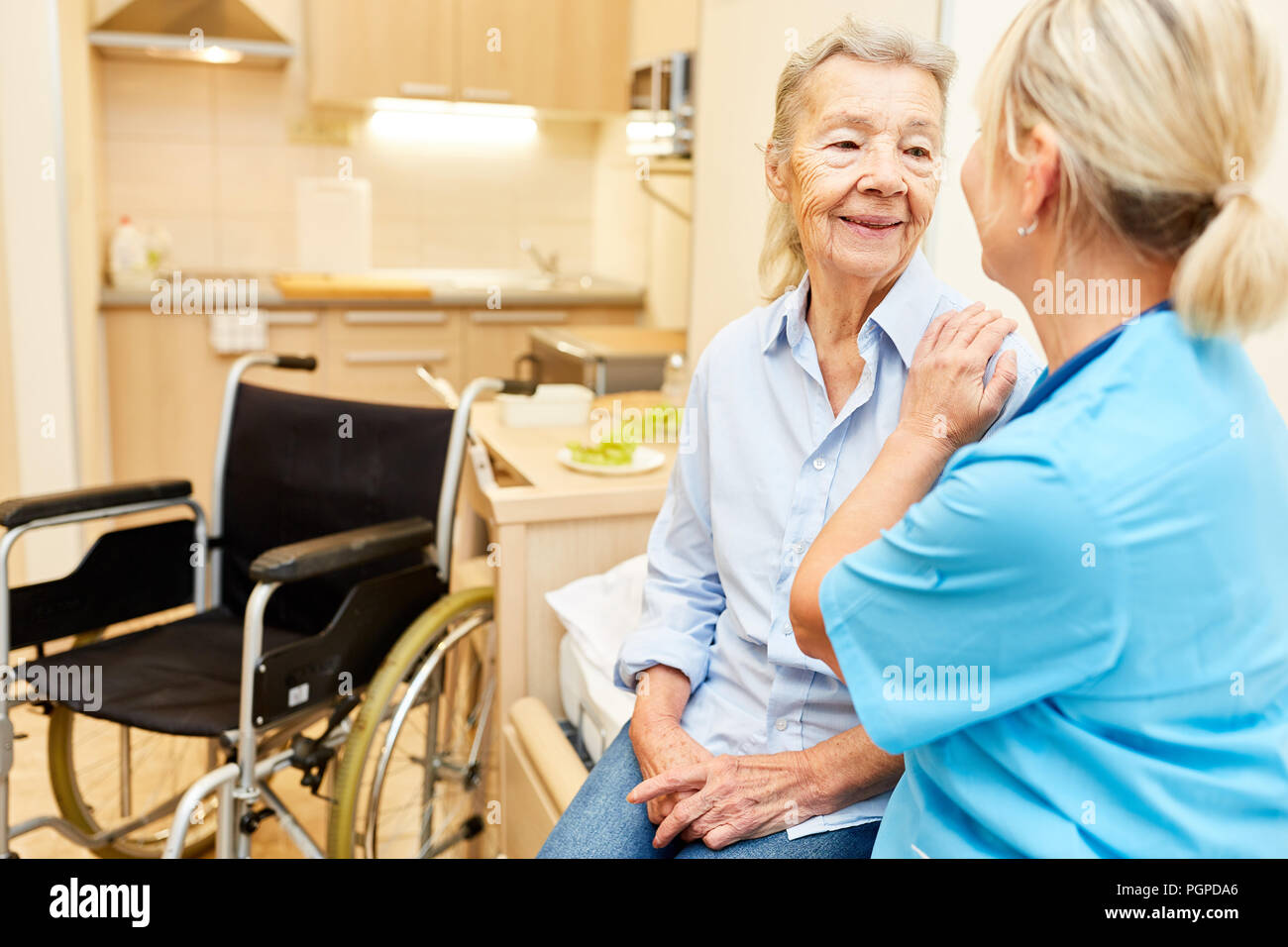 Social service consoles disabled senior woman in retirement home or ...