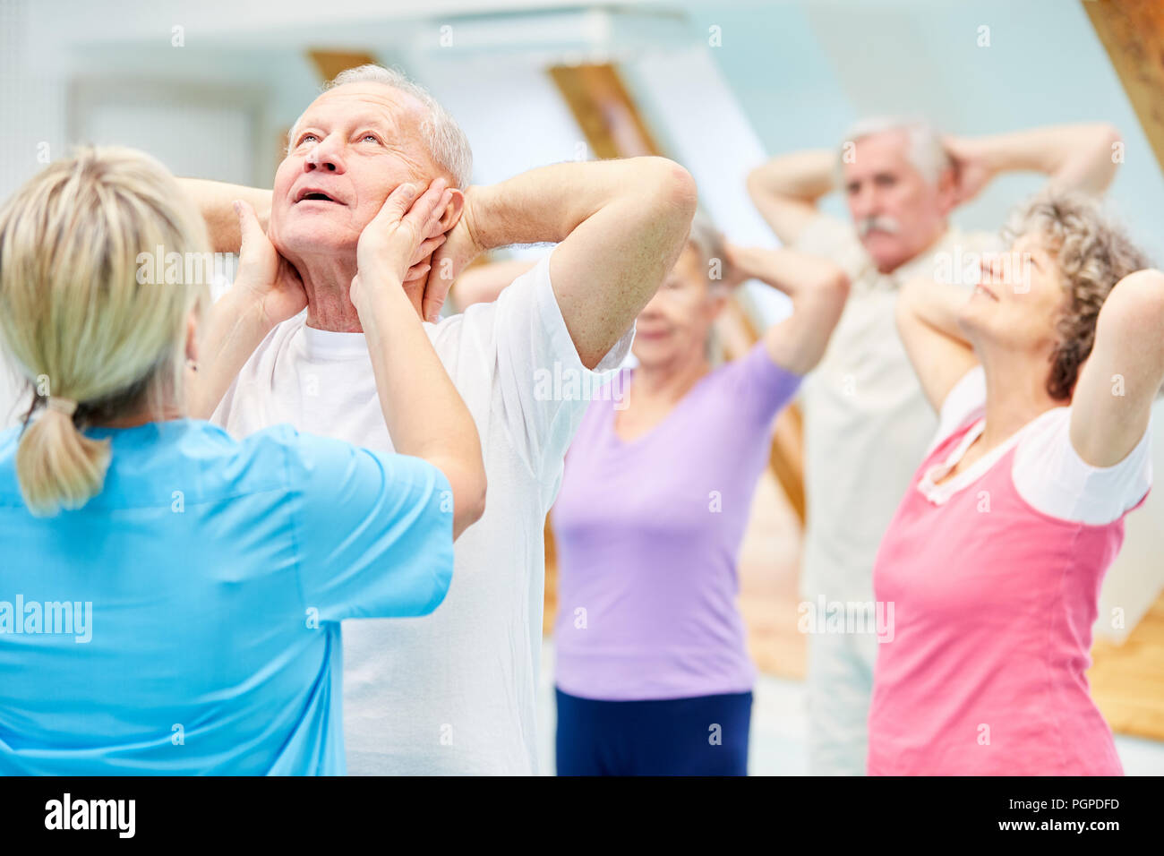 Senior group does physiotherapy with trainer in a physiotherapy Stock ...