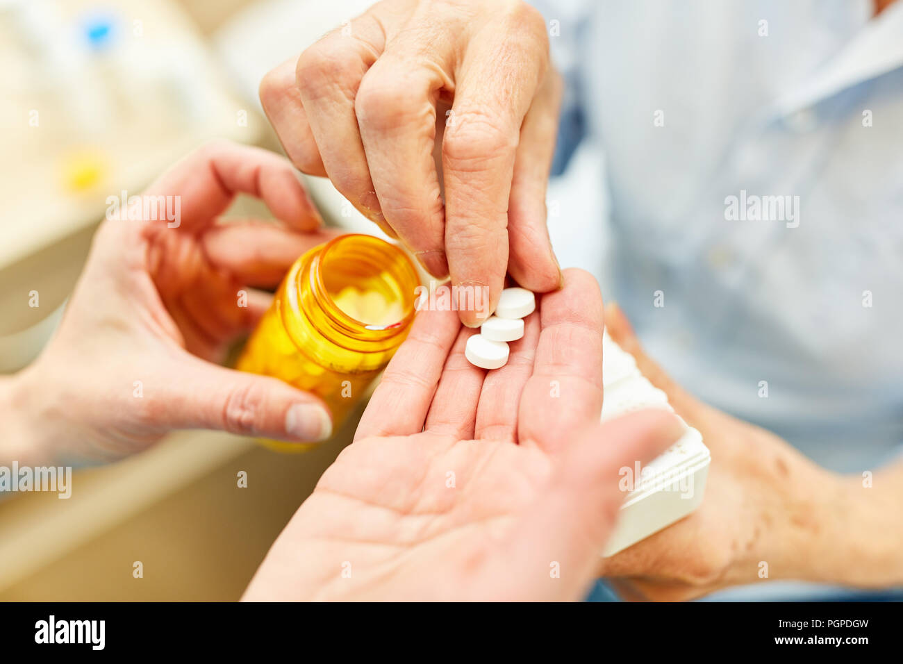 Nursing woman distributes tablets in the correct dosage to sick ...