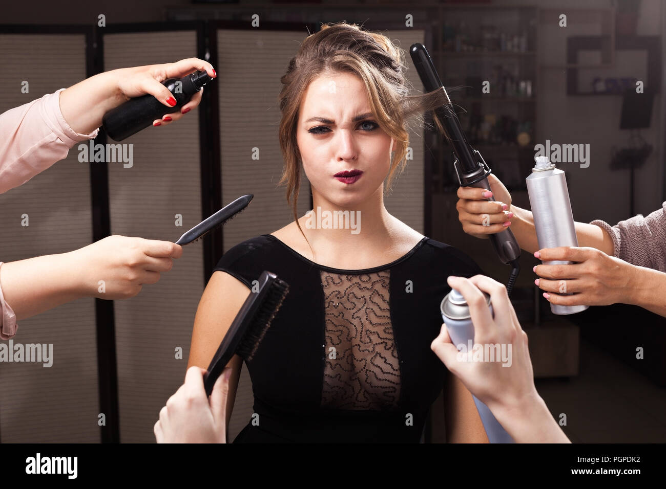 wriggling model surrounded by hands with makeup products Stock Photo ...