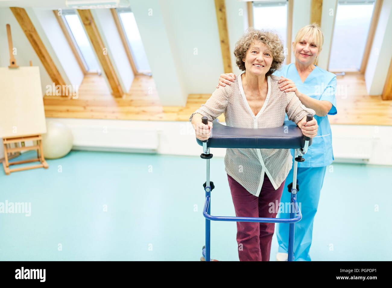 Senior patient as a patient learns to walk with the walker with ...