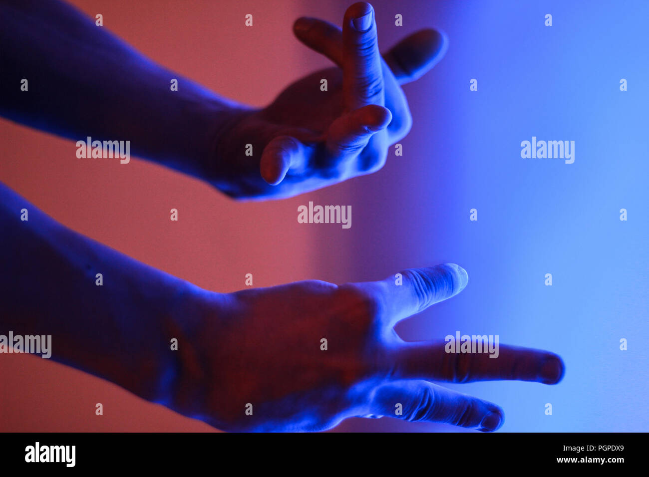 Human hands in red and blue color neon fluorescent light Stock Photo ...