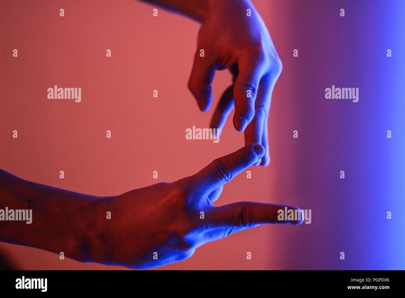 Human hands in red and blue color neon fluorescent light Stock Photo ...