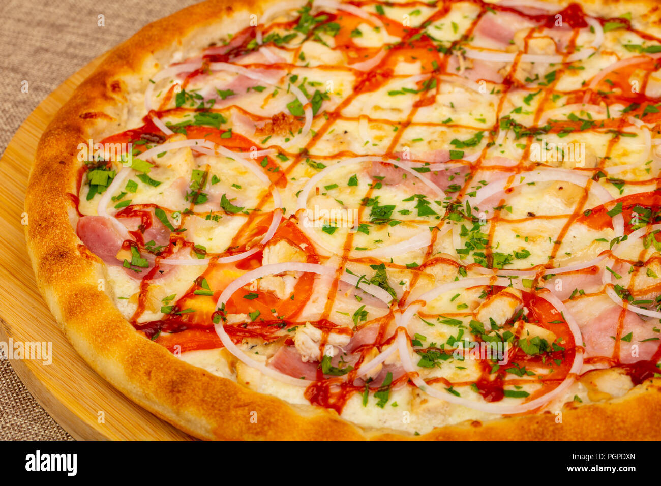 Pizza with ham, cheese and chicken Stock Photo - Alamy