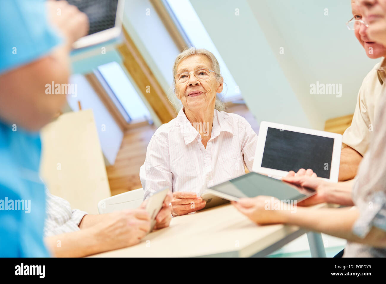 Seniors learn how to use the Internet in a computer course in a ...
