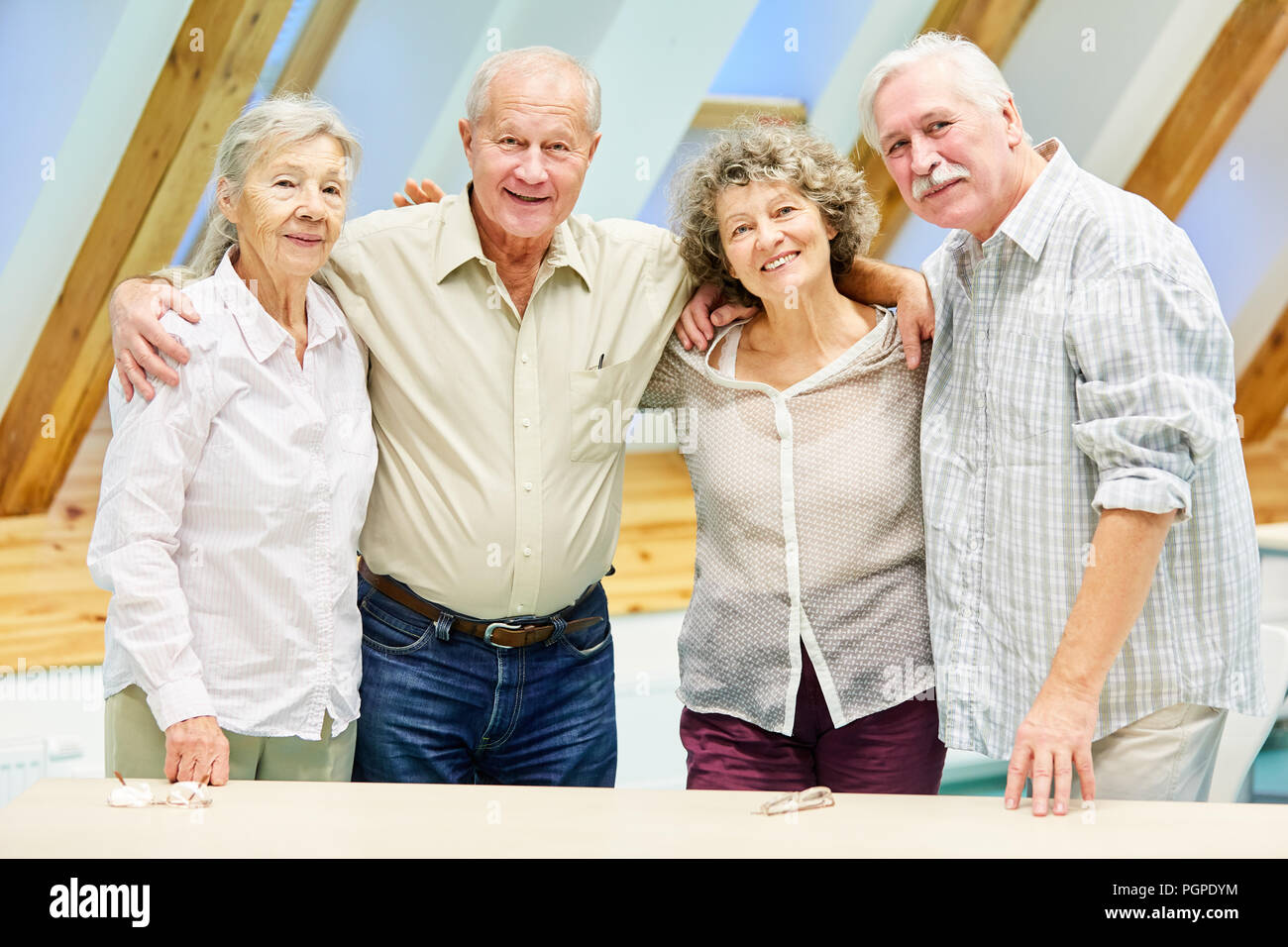 Group of seniors retired as friends in retirement home smiling happily ...