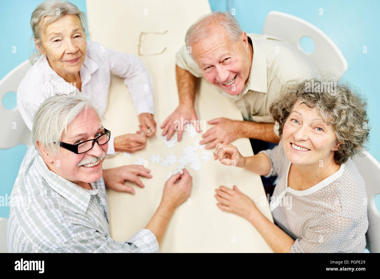 Seniors as a retired group have fun playing in the retirement home or ...