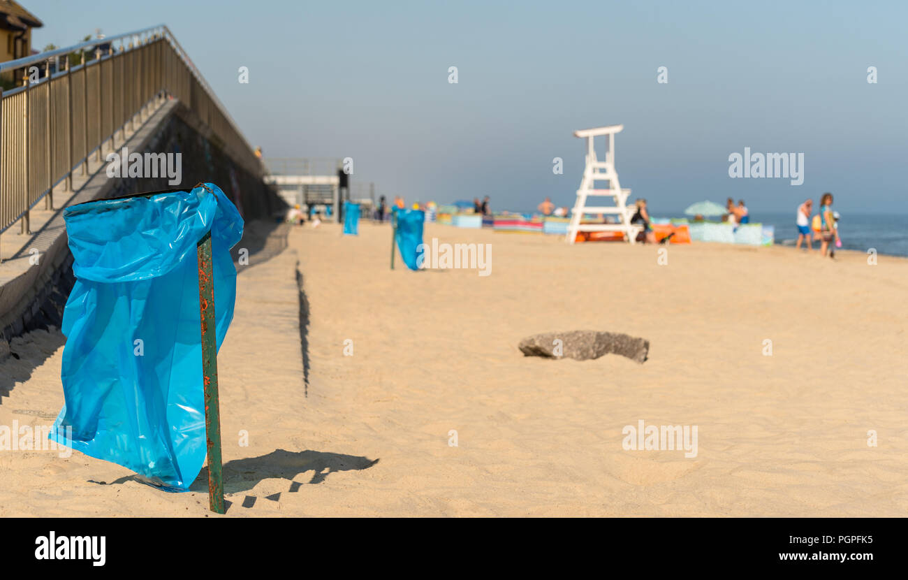 An empty garbage bag on the beach on a sunny summer day, in the ...