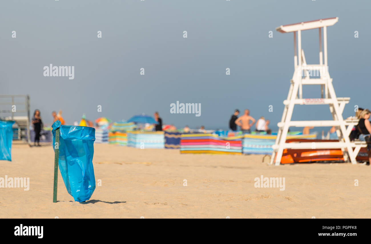 An empty garbage bag on the beach on a sunny summer day, in the ...