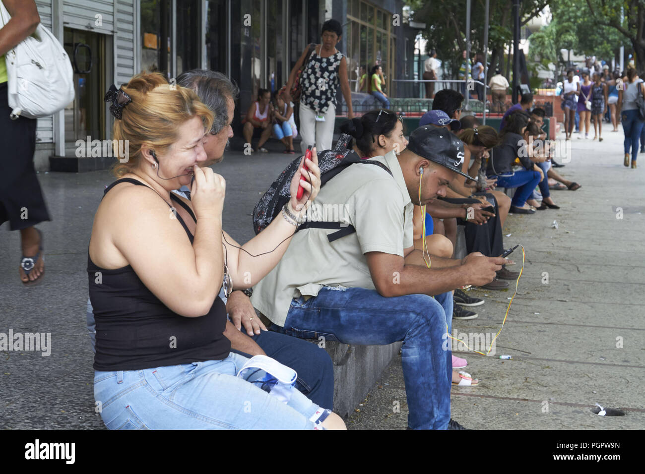 Havana, Cuba. 4th Nov, 2015. A woman uses a local wifi spot to talk to ...
