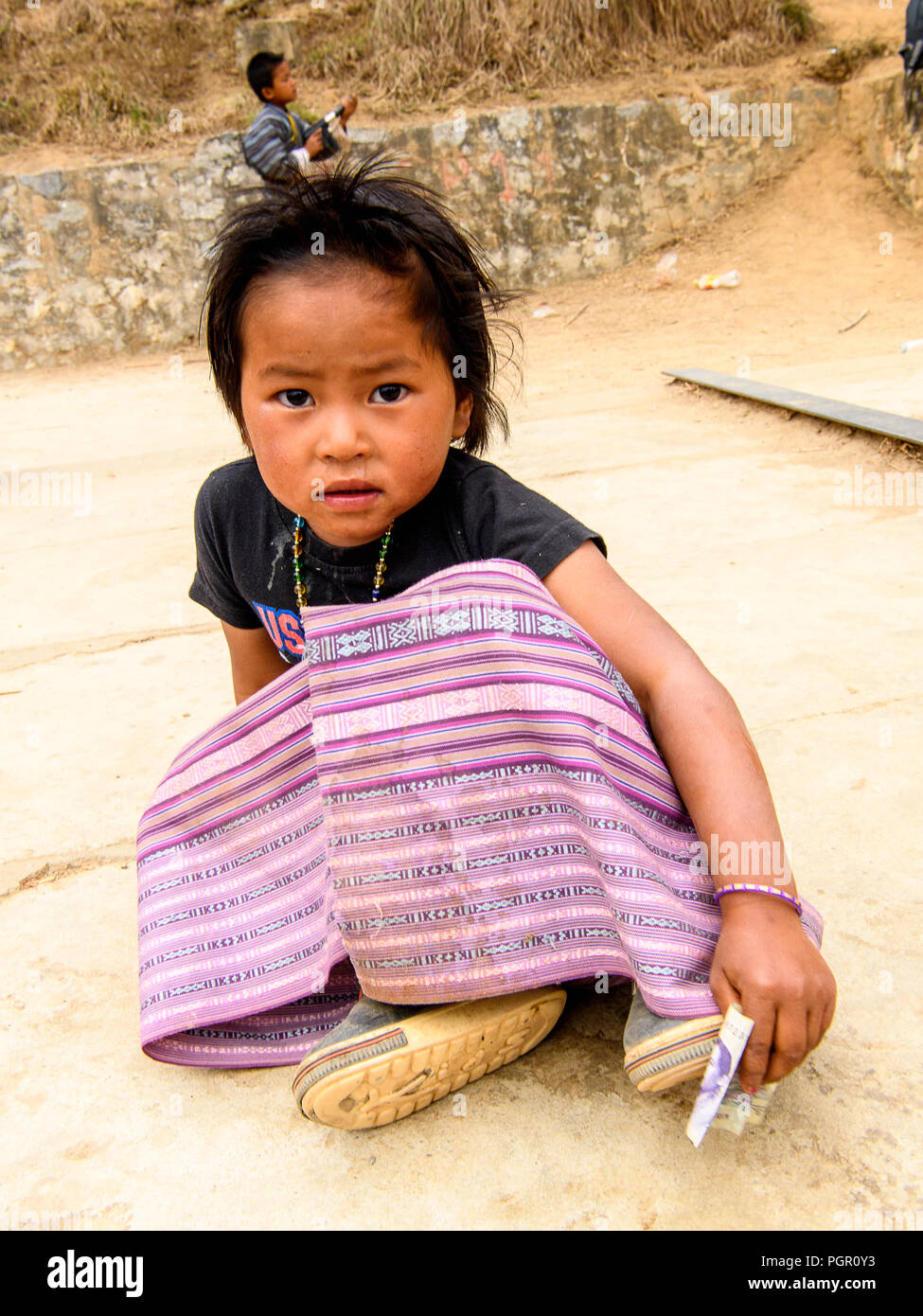 TRIMPHU, BHUTAN - MAR 8, 2017: Unidentified Ngalops little girl sits on ...