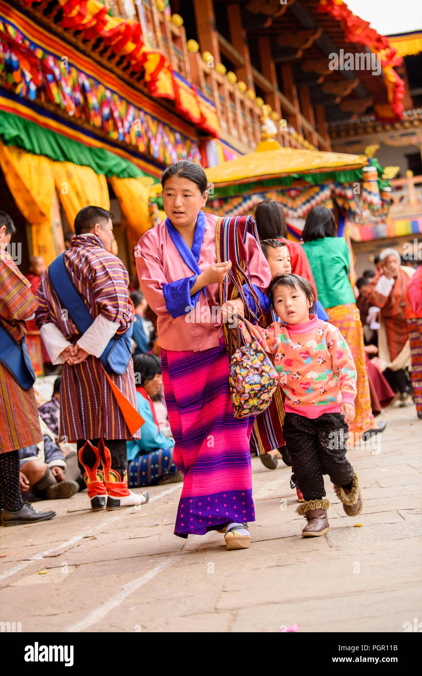 TRIMPHU, BHUTAN - MAR 8, 2017: Unidentified Ngalops woman walks with a ...
