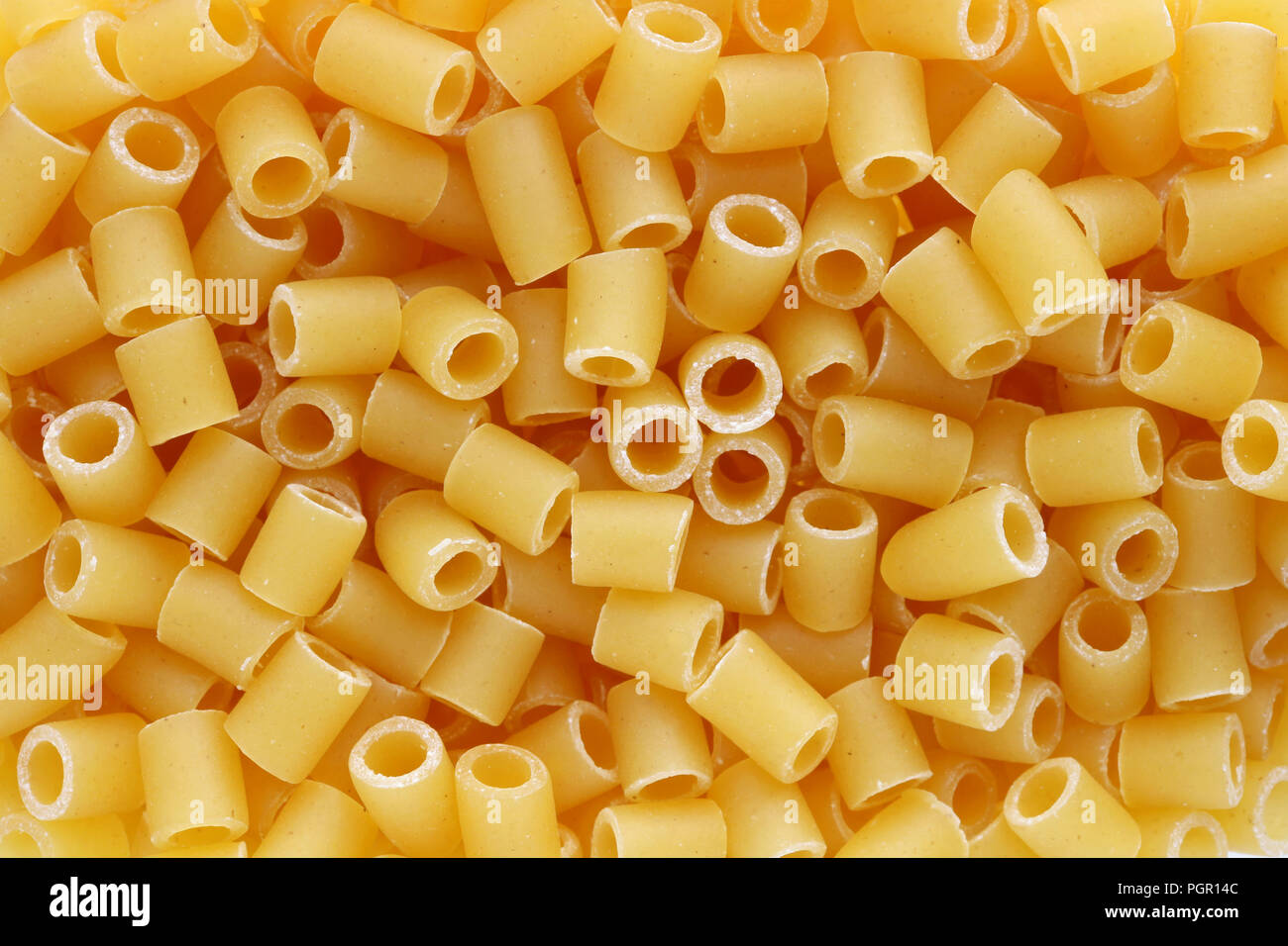 Dry small pasta in the form of short dough tubes studio food macro ...