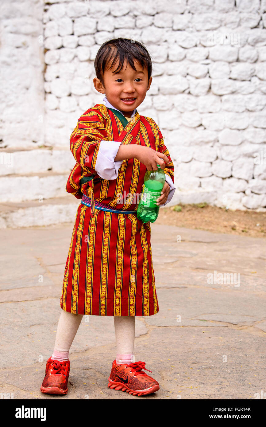TRIMPHU, BHUTAN - MAR 8, 2017: Unidentified Ngalops little boy walks ...