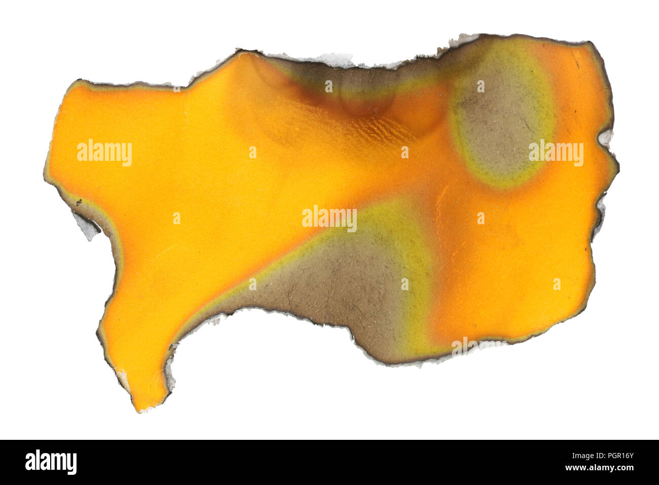 A small piece of a glossy magazine yellow page burnt in the fire ...