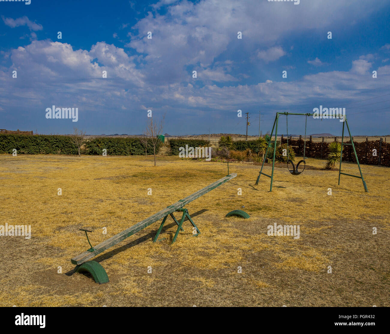 Empty playground against a background of blue sky and white clouds ...