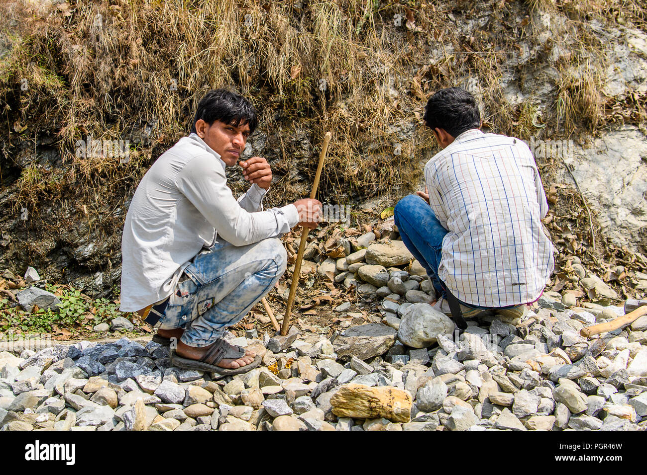 SIKKIM, INDIA - MAR 13, 2017: Unidentified Indian two men squat on the ...