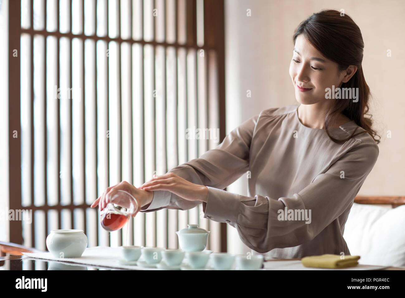 Young woman performing tea ceremony Stock Photo - Alamy