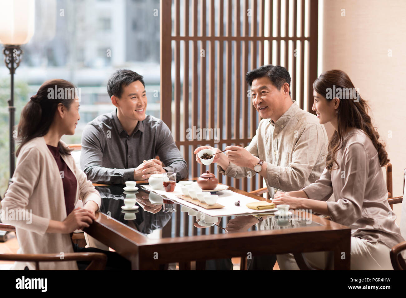 Friends drinking tea together Stock Photo - Alamy