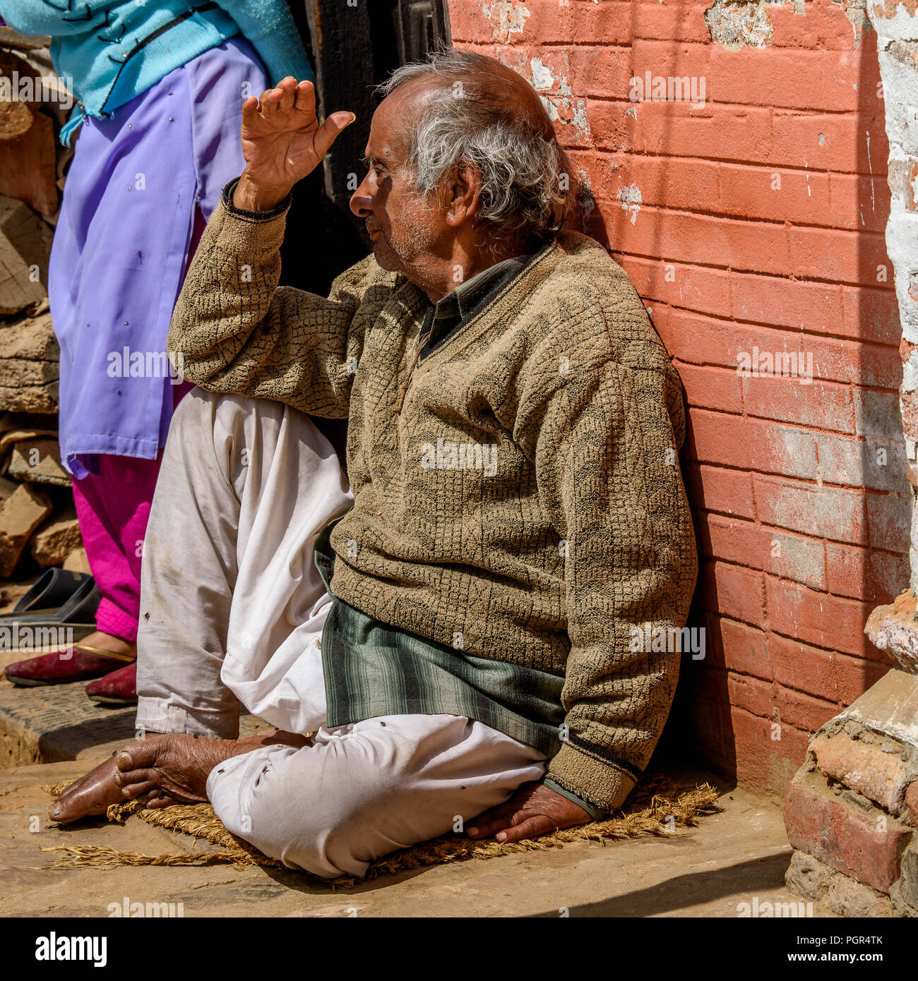 KATMANDU, NEPAL - MAR 6, 2017: Unidentified Chhetri man leans on the ...
