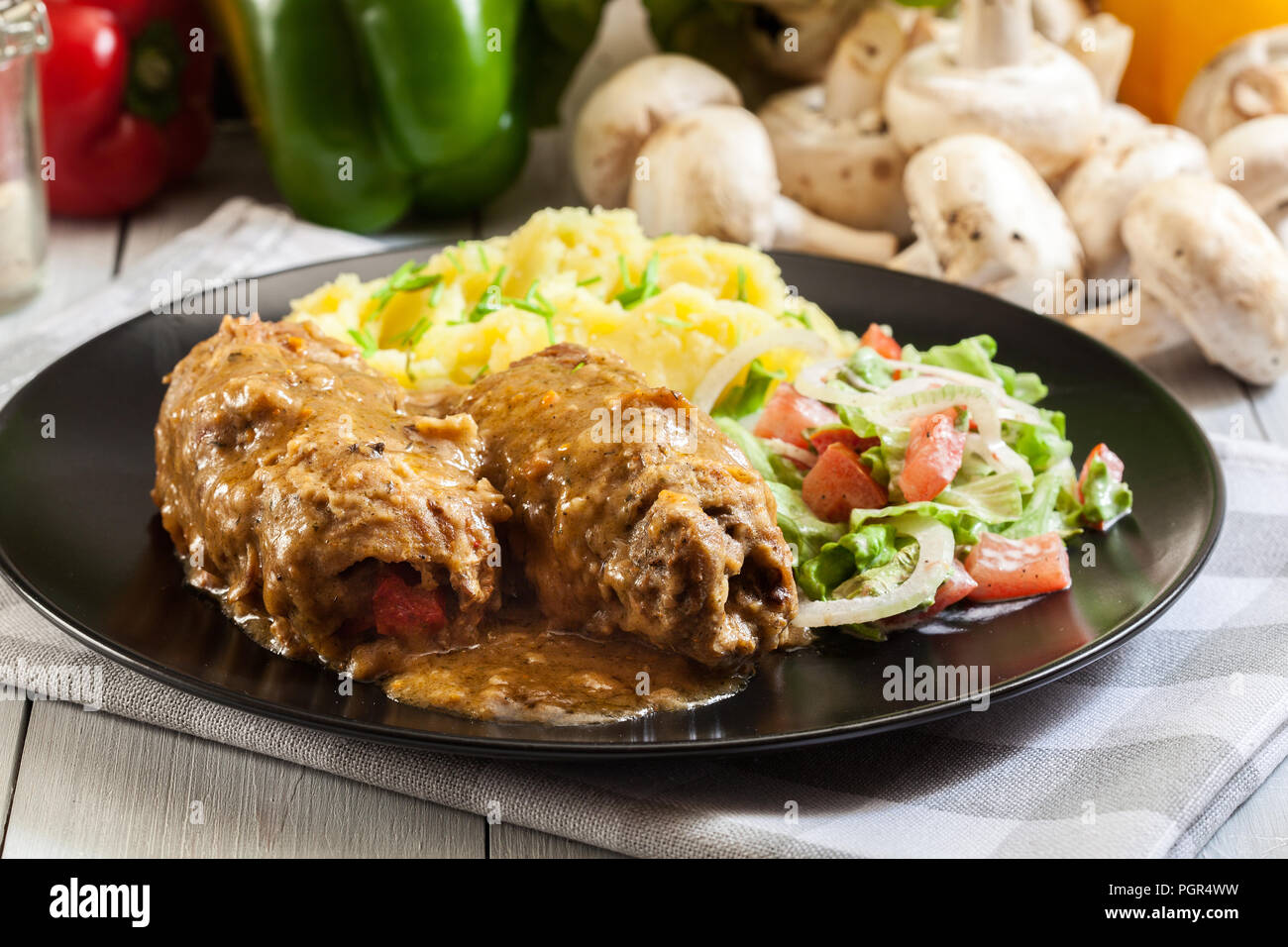 Pork rolls in sauce served with mashed potatoes and salad Stock Photo ...