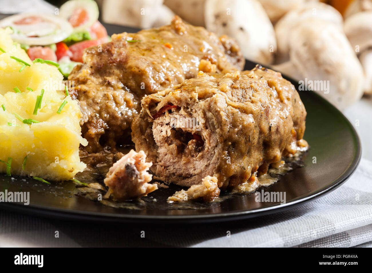 Pork rolls in sauce served with mashed potatoes and salad Stock Photo ...