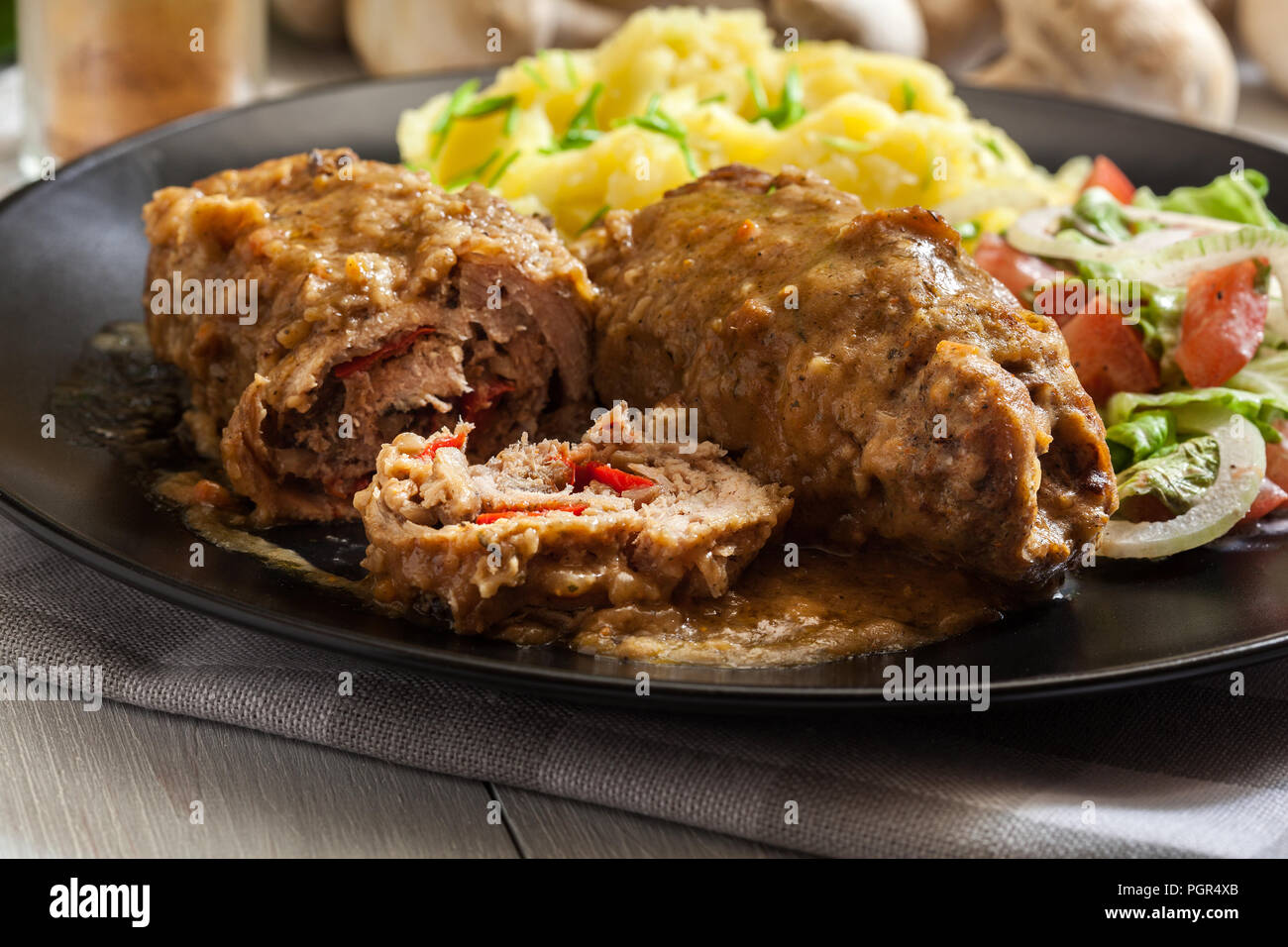 Pork rolls in sauce served with mashed potatoes and salad Stock Photo ...