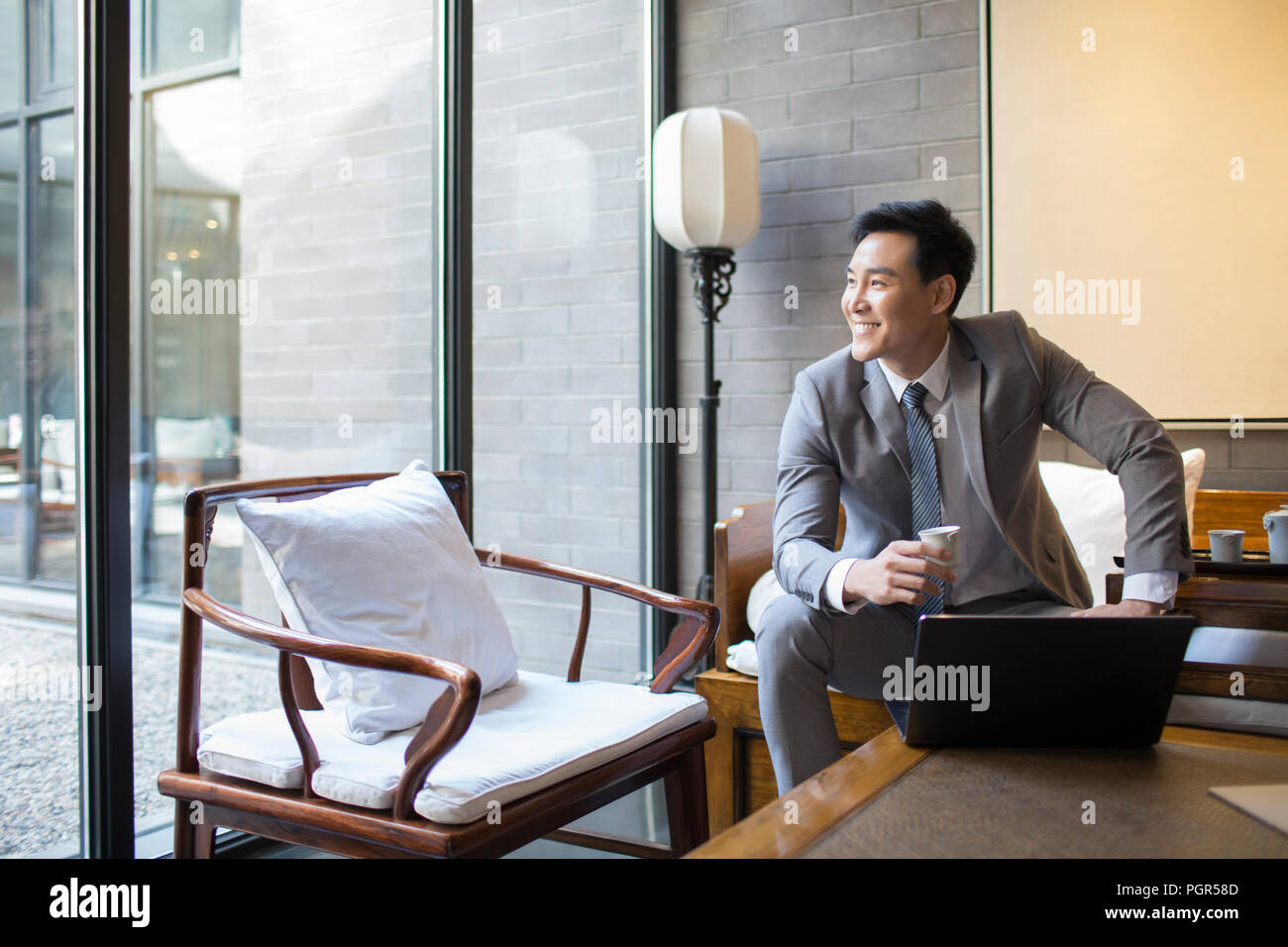 Confident businessman thinking Stock Photo - Alamy