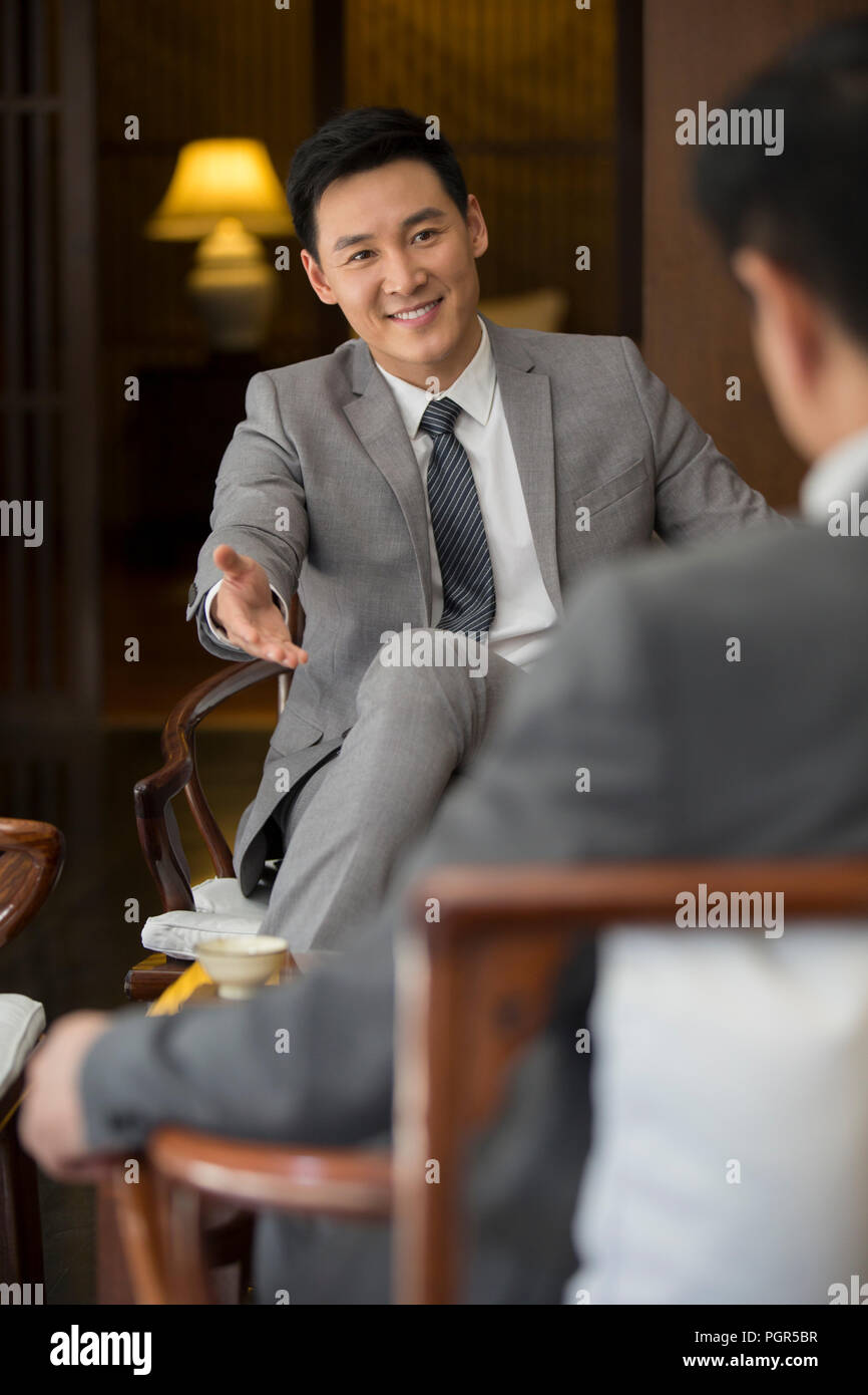Cheerful businessmen talking in tea room Stock Photo - Alamy