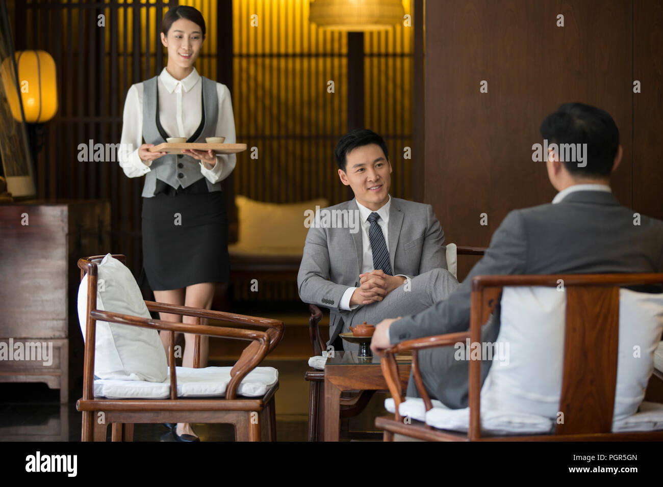 Cheerful businessmen talking in tea room Stock Photo - Alamy