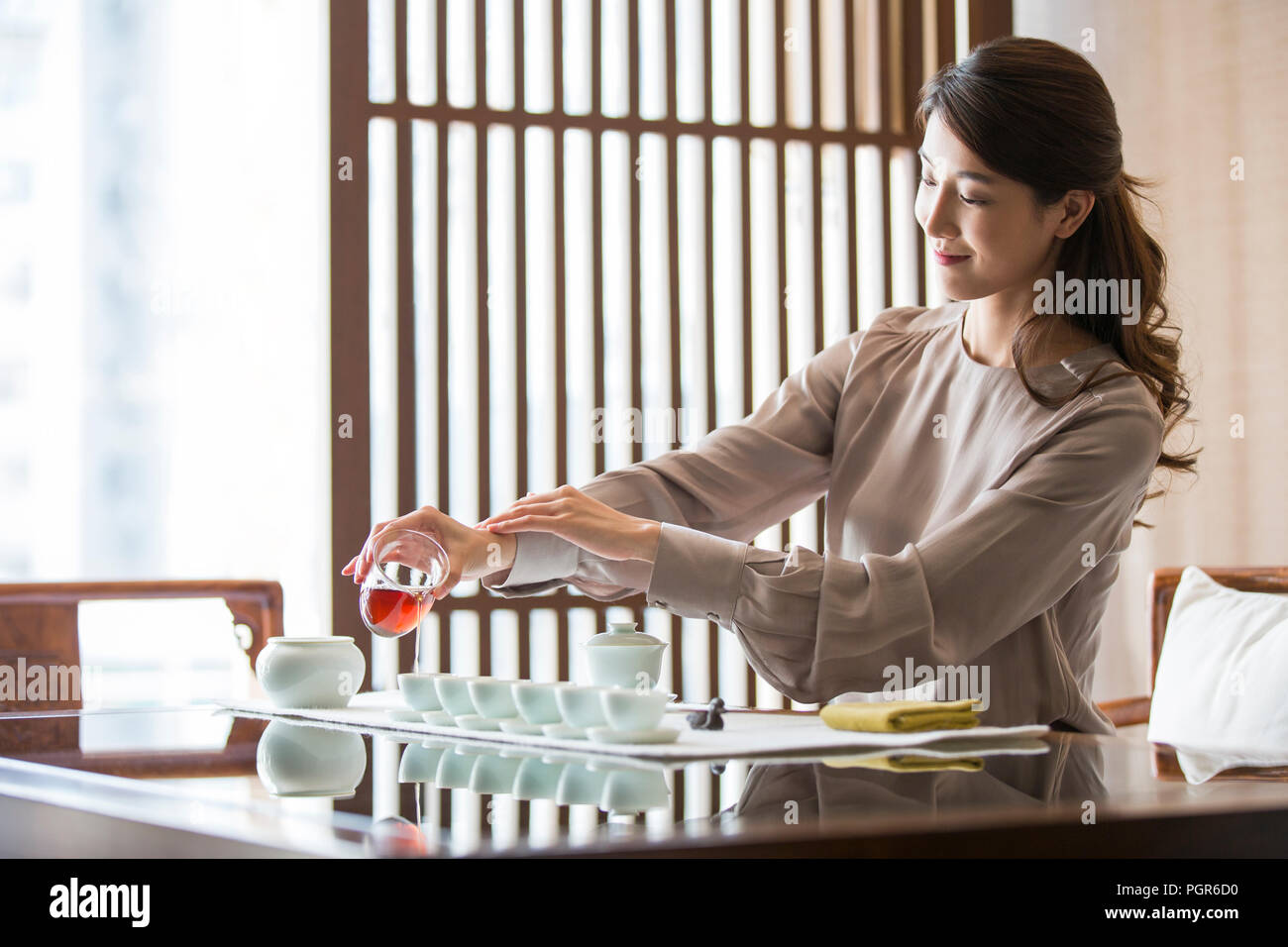 Young woman performing tea ceremony Stock Photo - Alamy