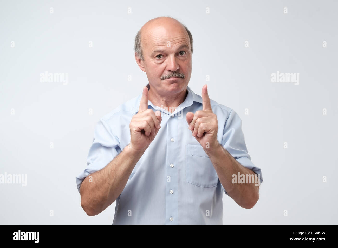 Portrait of pissed off senior european guy, shaking index finger, being ...