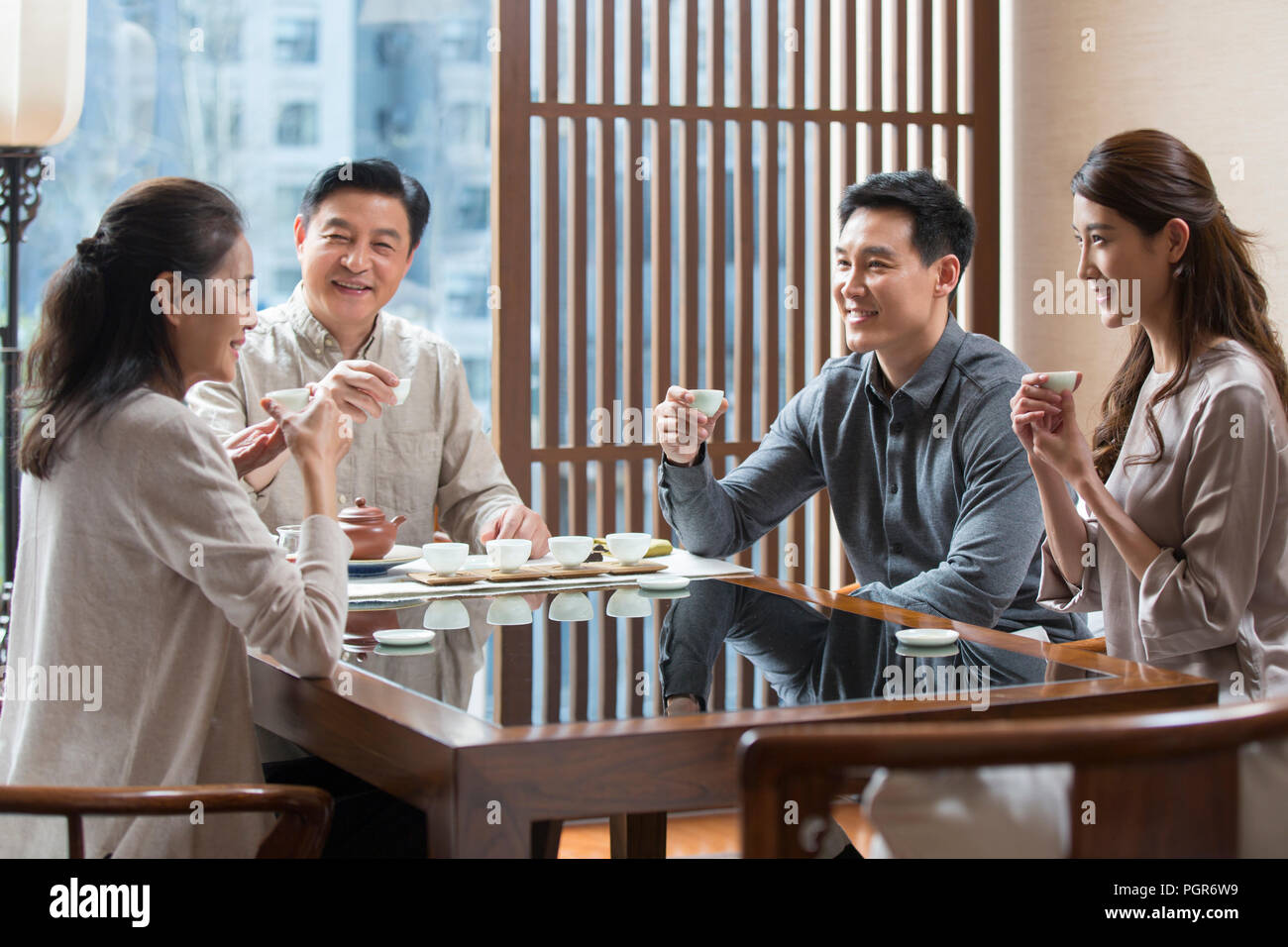Friends drinking tea together Stock Photo - Alamy
