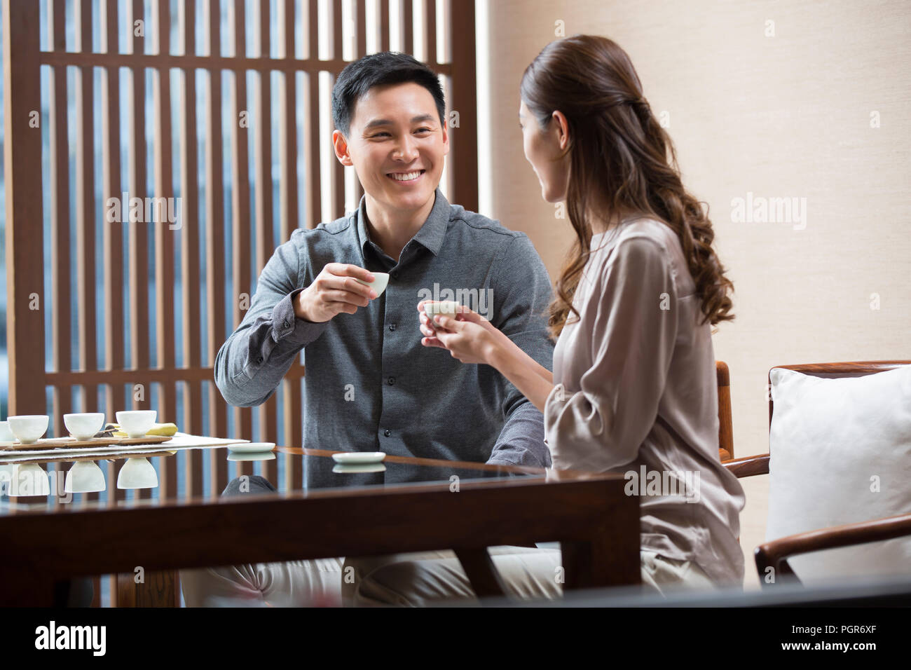 Cheerful couple drinking tea Stock Photo - Alamy