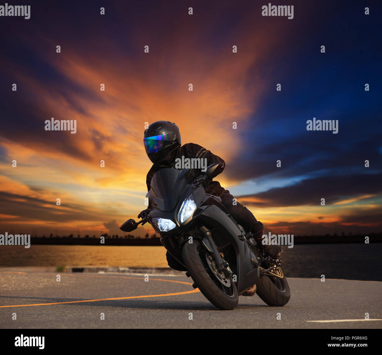 young man riding big bike motorcycle leaning curve on asphalt highways ...