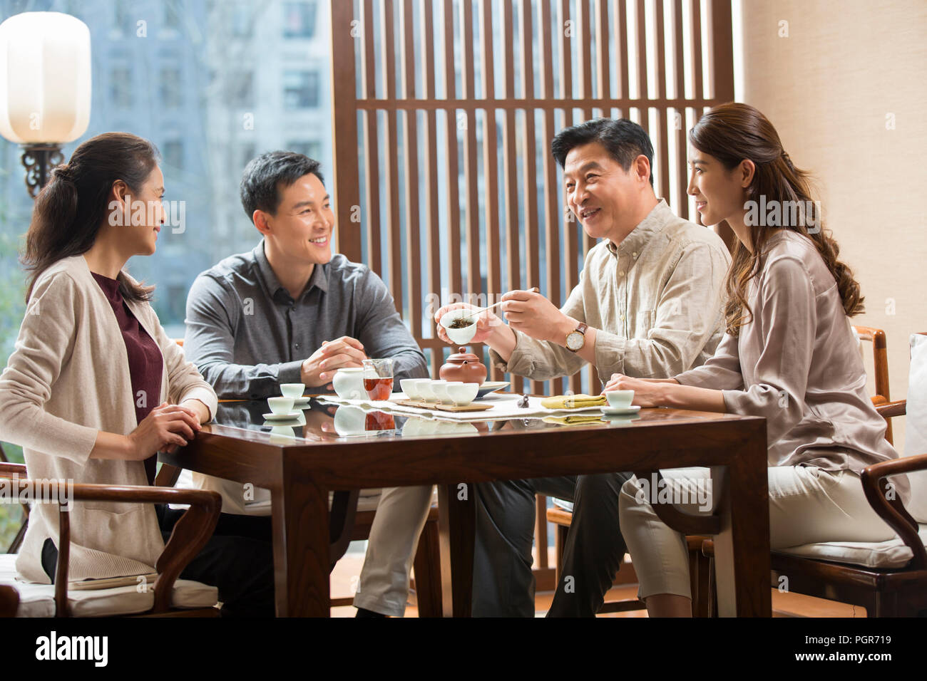 Friends drinking tea together Stock Photo - Alamy