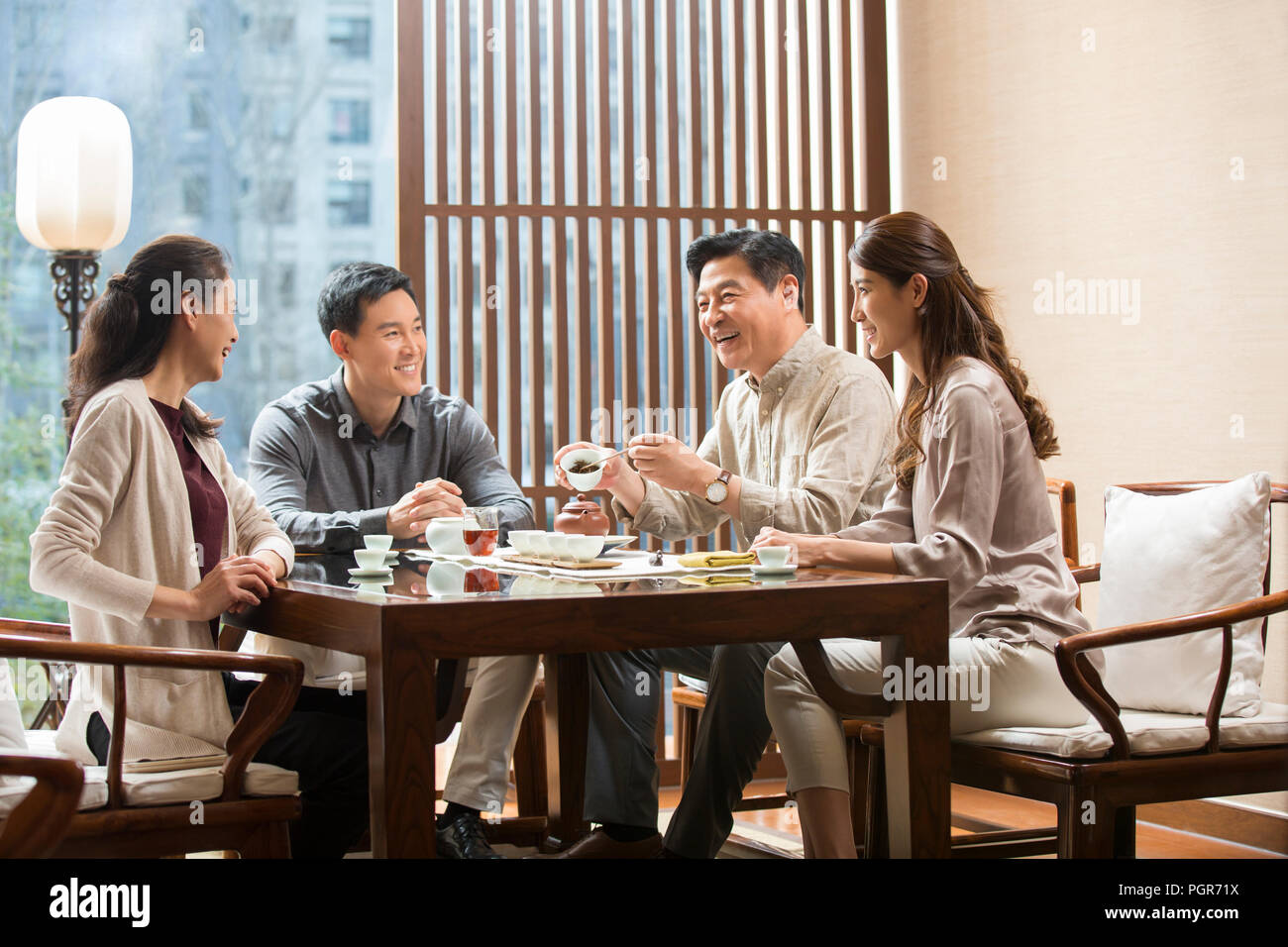 Friends drinking tea together Stock Photo - Alamy