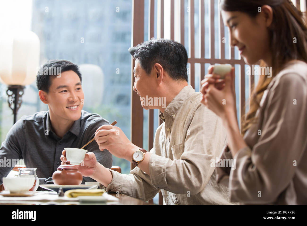 Friends drinking tea together Stock Photo - Alamy