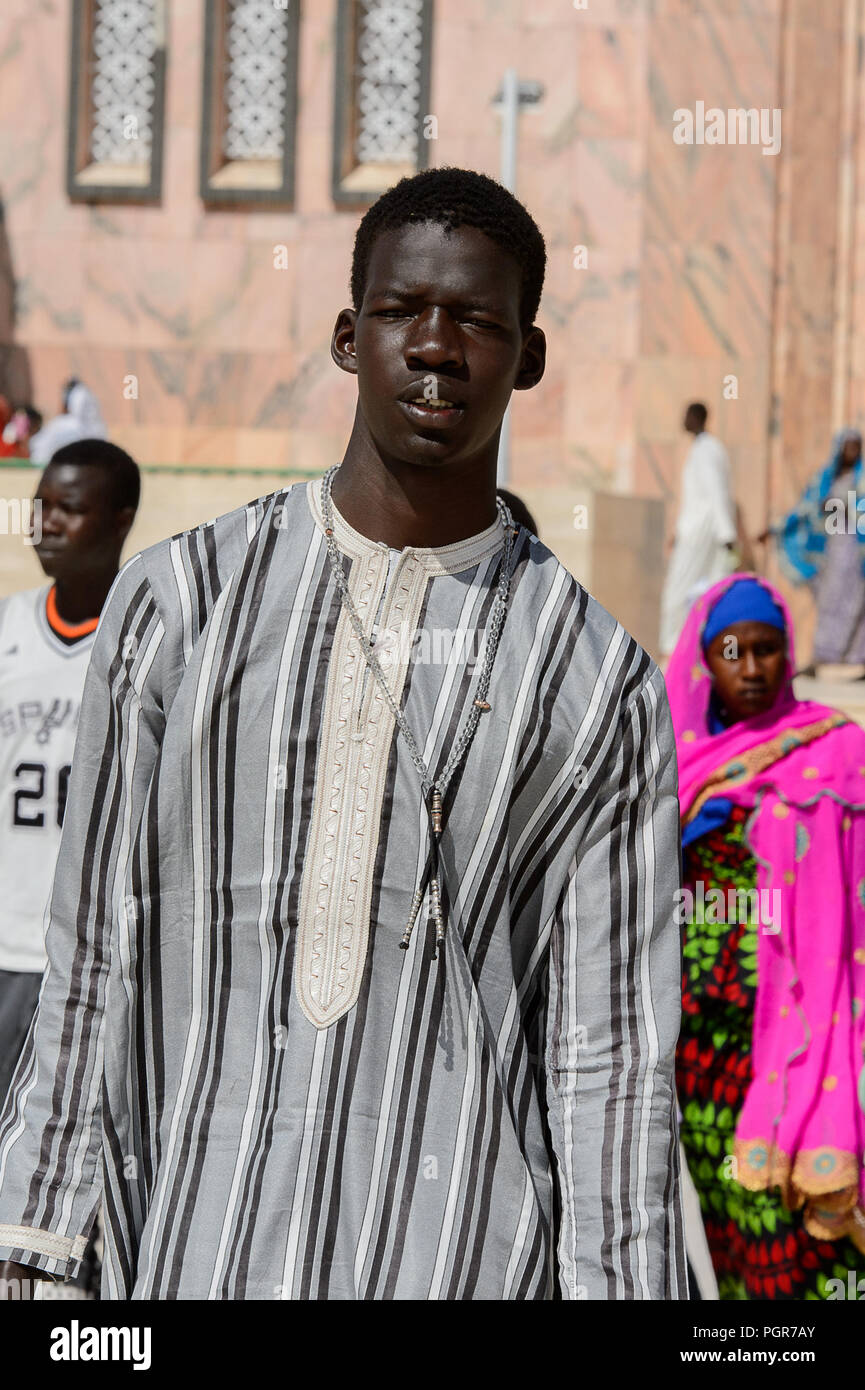 TOUBA, SENEGAL - APR 26, 2017: Unidentified Senegalese man in colored ...