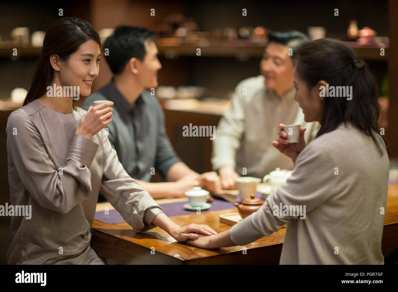 Friends drinking tea together Stock Photo - Alamy