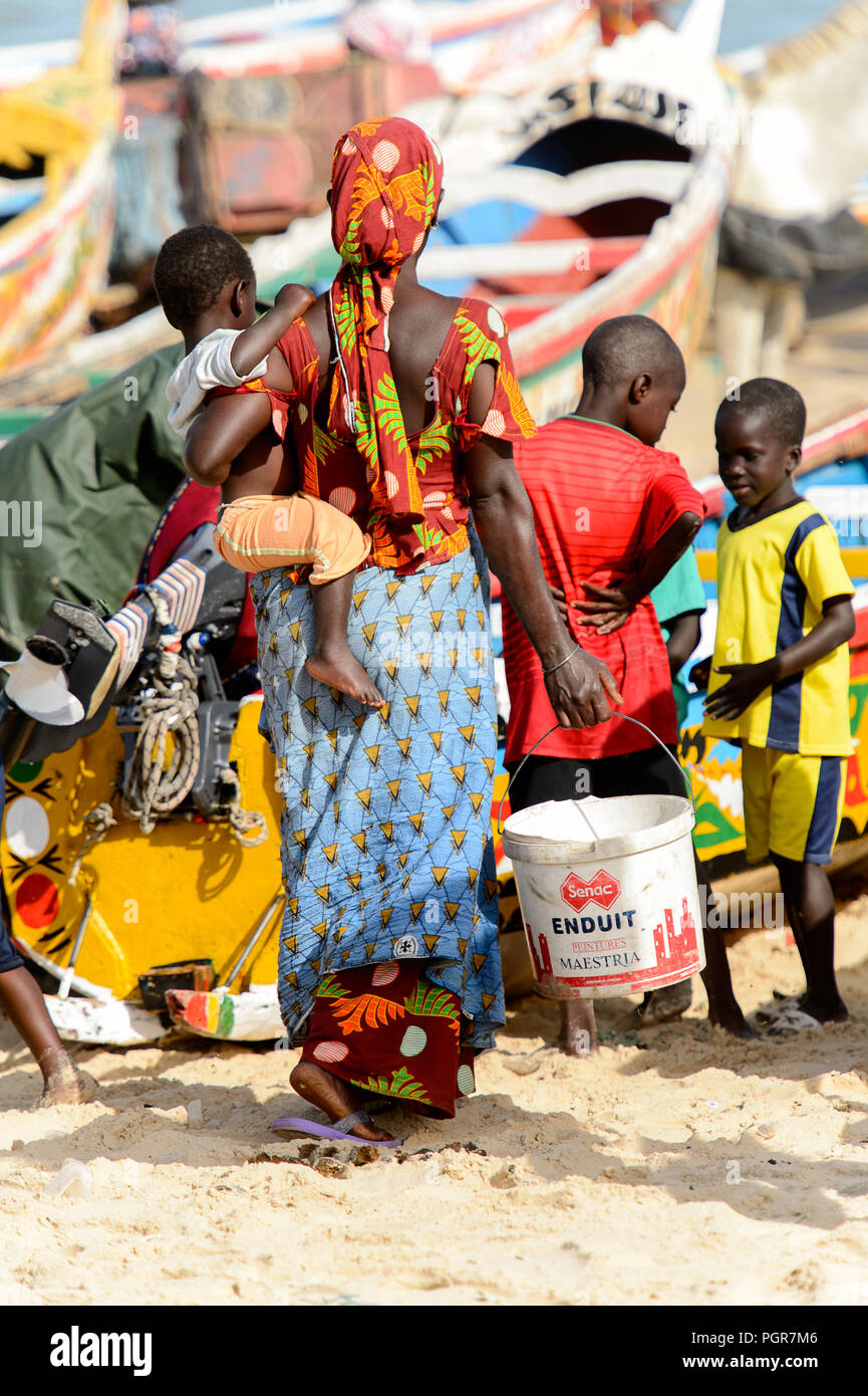 KAYAR, SENEGAL - APR 27, 2017: Unidentified Senegalese woman carries a ...