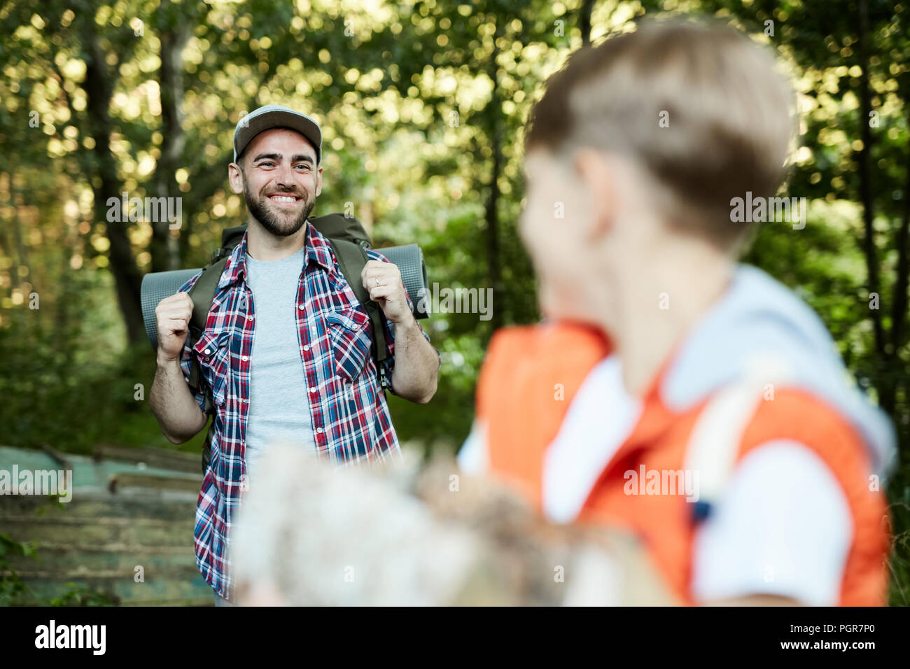Happy father with backpack is going camping with his son Stock Photo ...