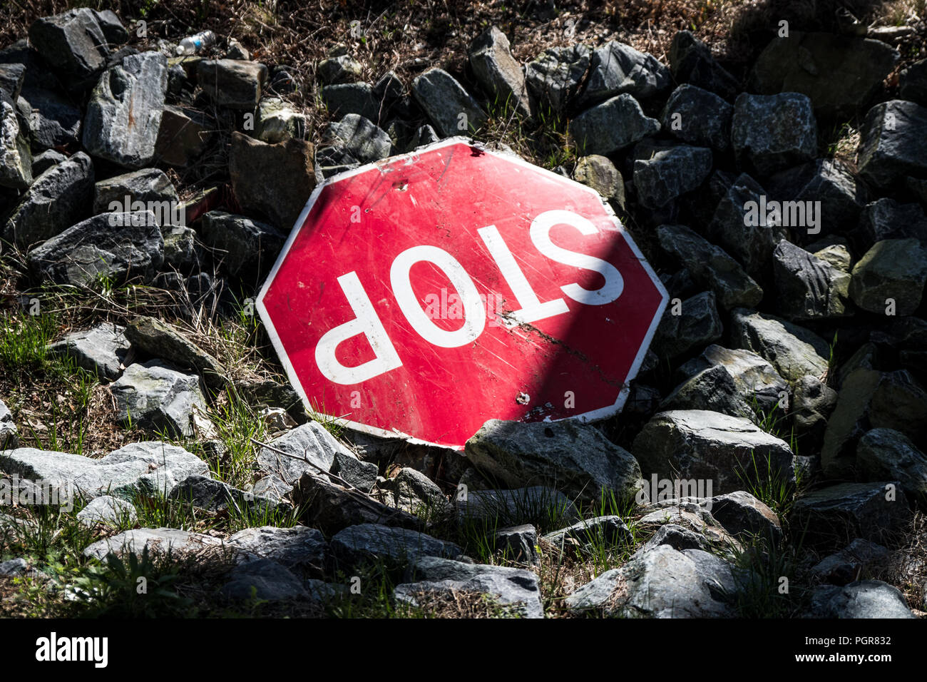 An abandoned broken stop sign thrown into the rocks Stock Photo - Alamy