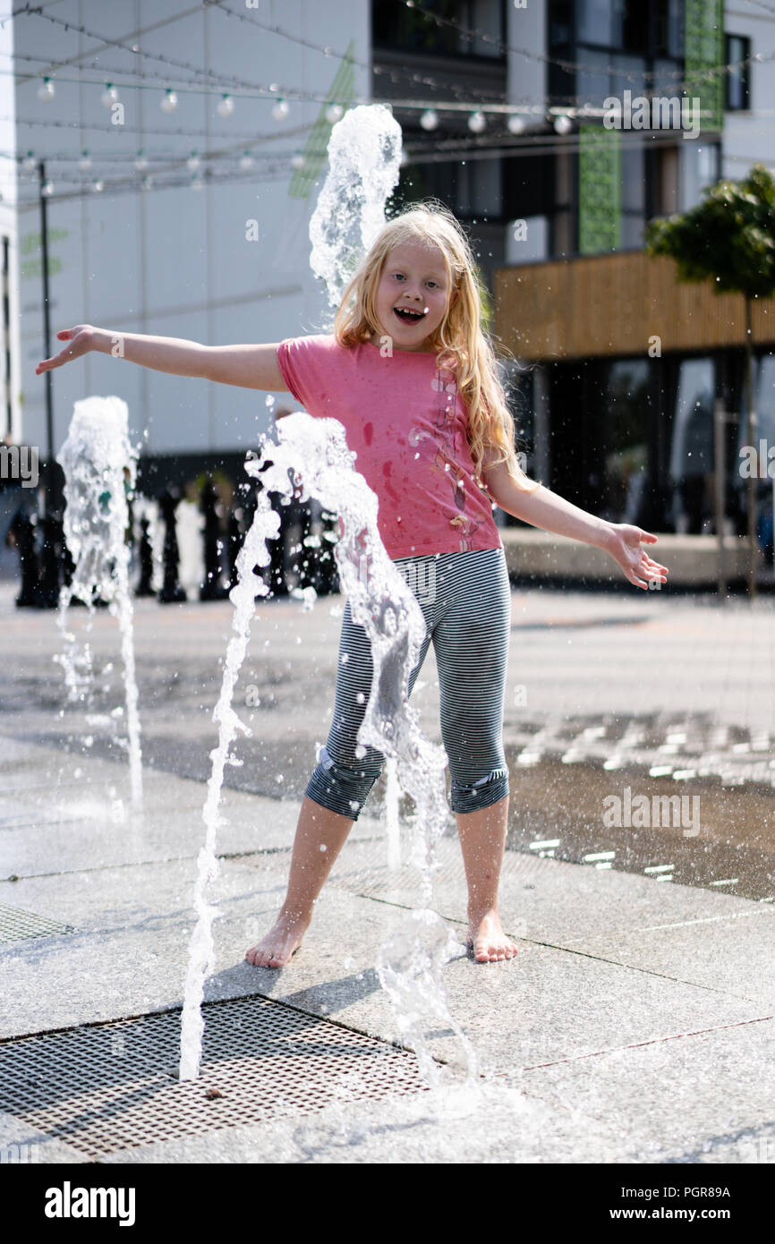 life of children in a modern city - little girl having fun with ...