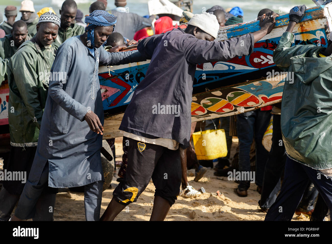 KAYAR, SENEGAL - APR 27, 2017: Unidentified Senegalese people pull the ...
