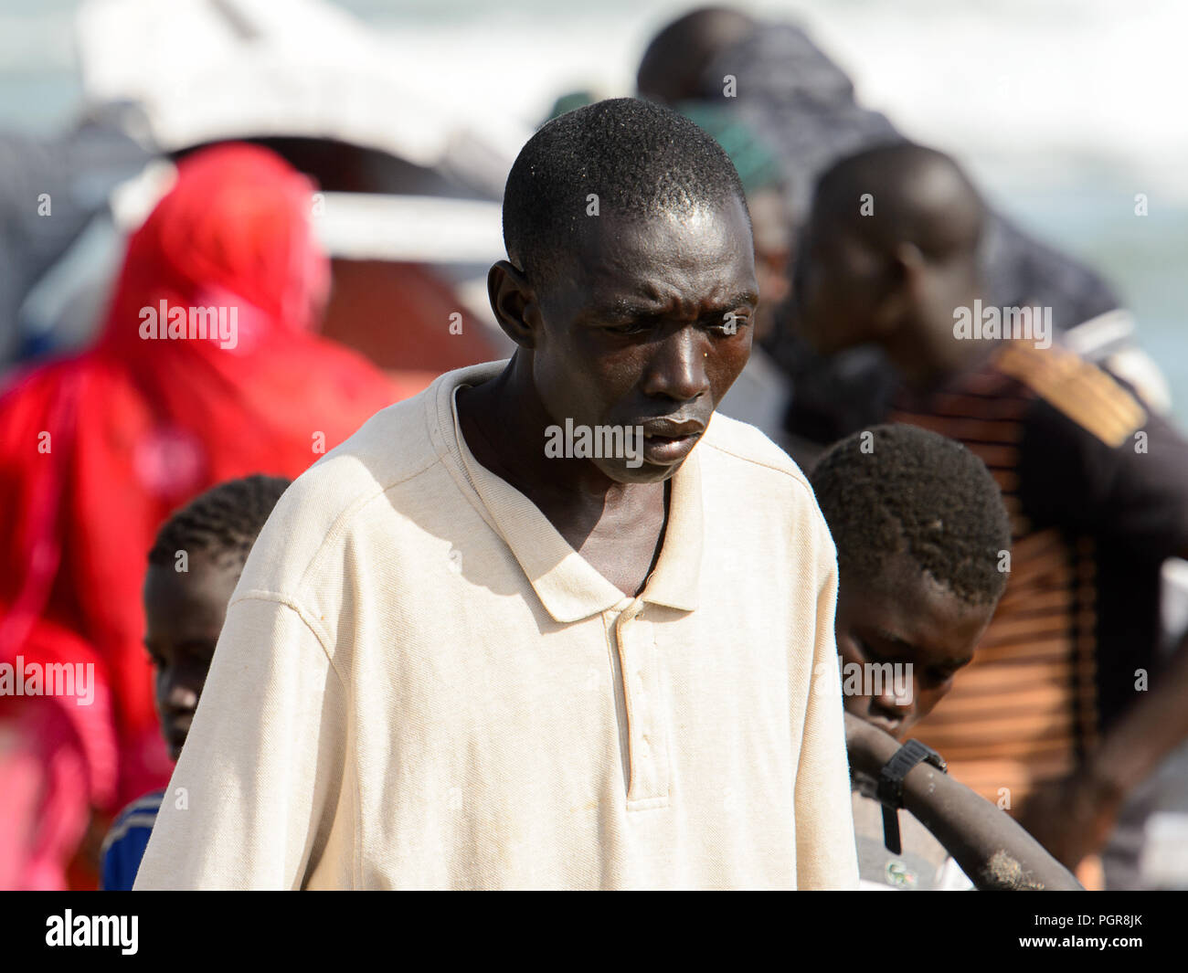 KAYAR, SENEGAL - APR 27, 2017: Unidentified Senegalese man looks down ...