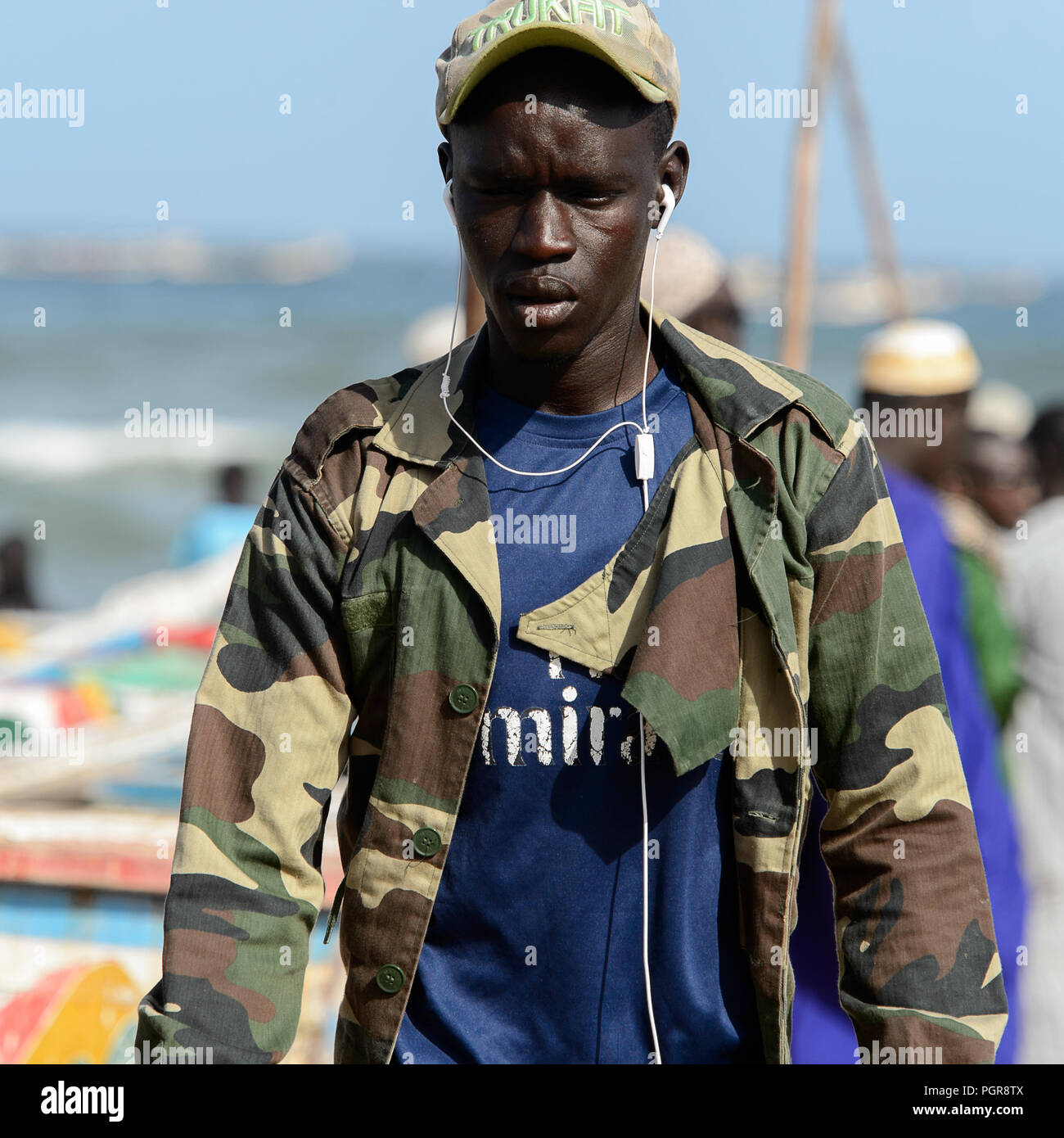 KAYAR, SENEGAL - APR 27, 2017: Unidentified Senegalese man listens to ...