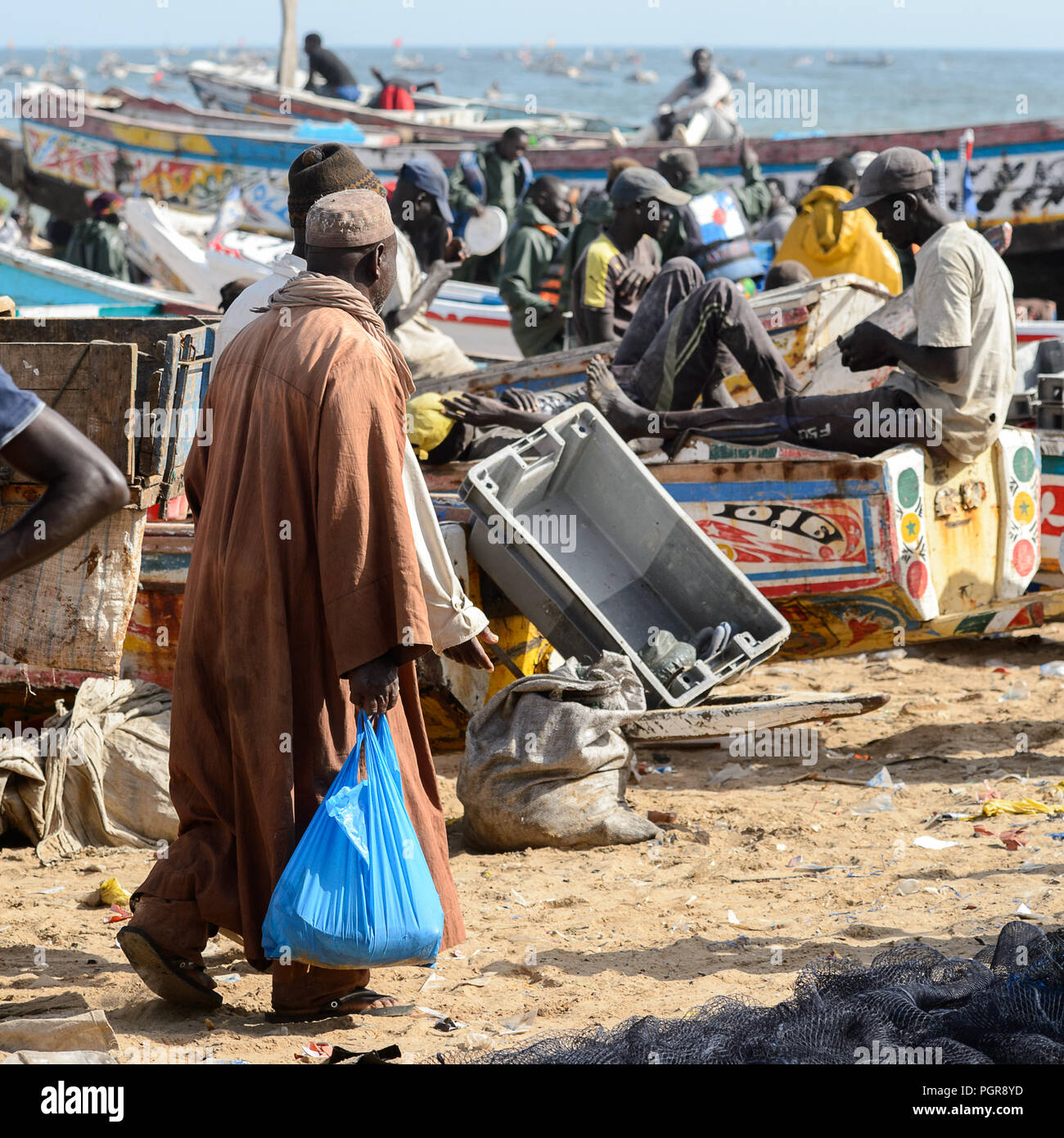 KAYAR, SENEGAL - APR 27, 2017: Unidentified Senegalese man walks with a ...